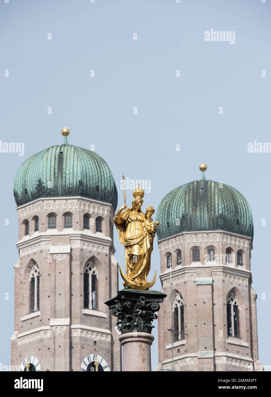 The statue of the Virgin Mary on Munich's Marienplatz with the towers ...