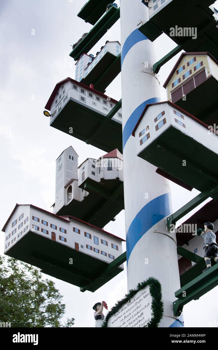 Maypole with church and traditional houses in the centre of Aubing ...