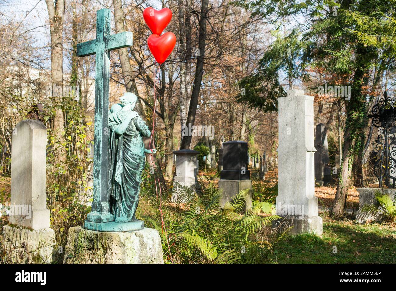 Grave figures decorated with heart-shaped balloons at the Old South ...