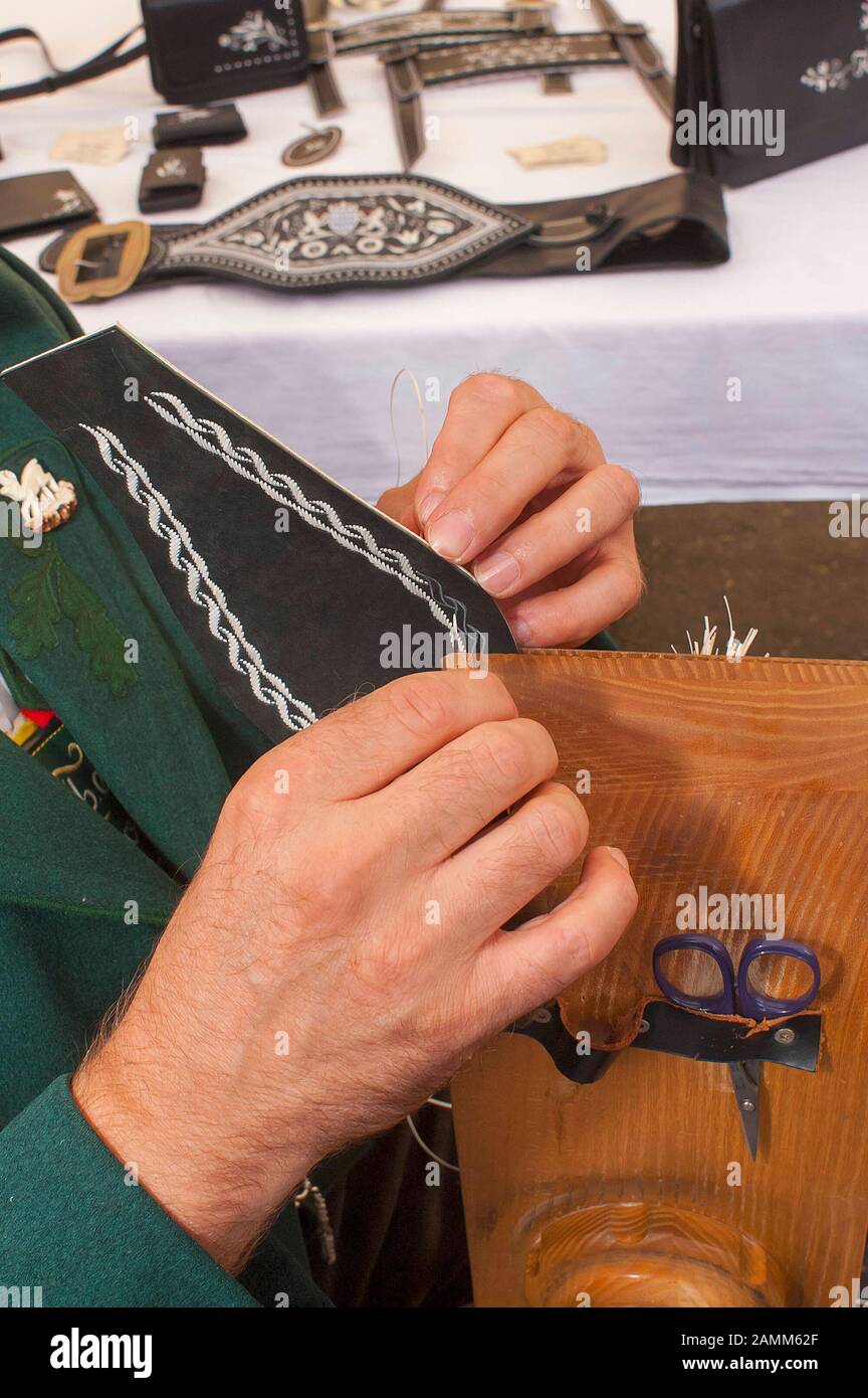 the quill stitcher at his work on a satchel [automated translation ...