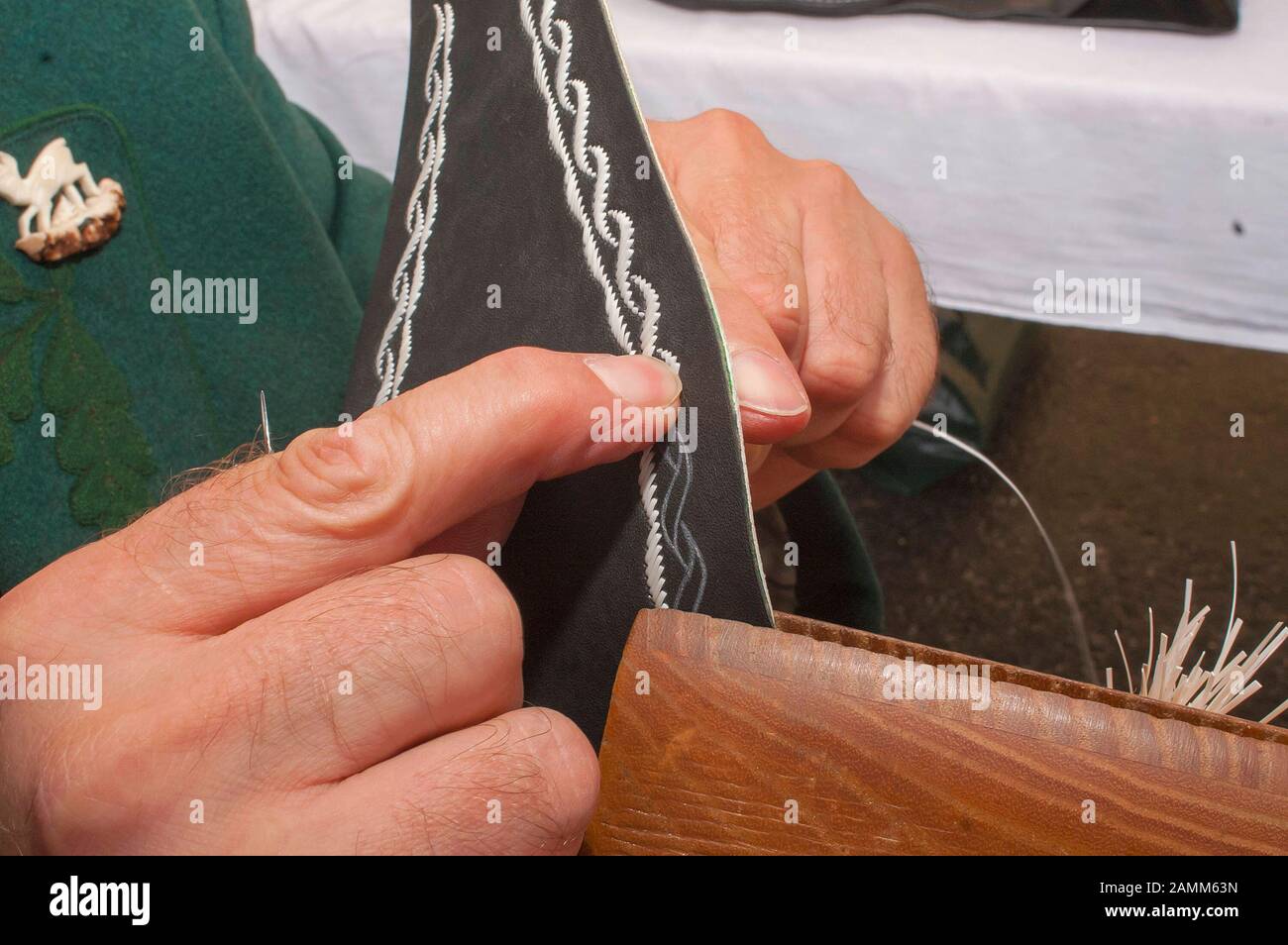the quill stitcher at his work on a satchel [automated translation ...