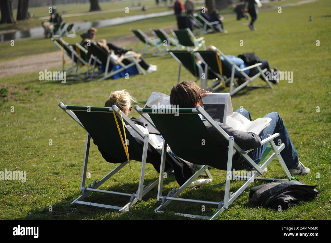 Sunbathing in deck chairs at springlike temperatures in the English ...