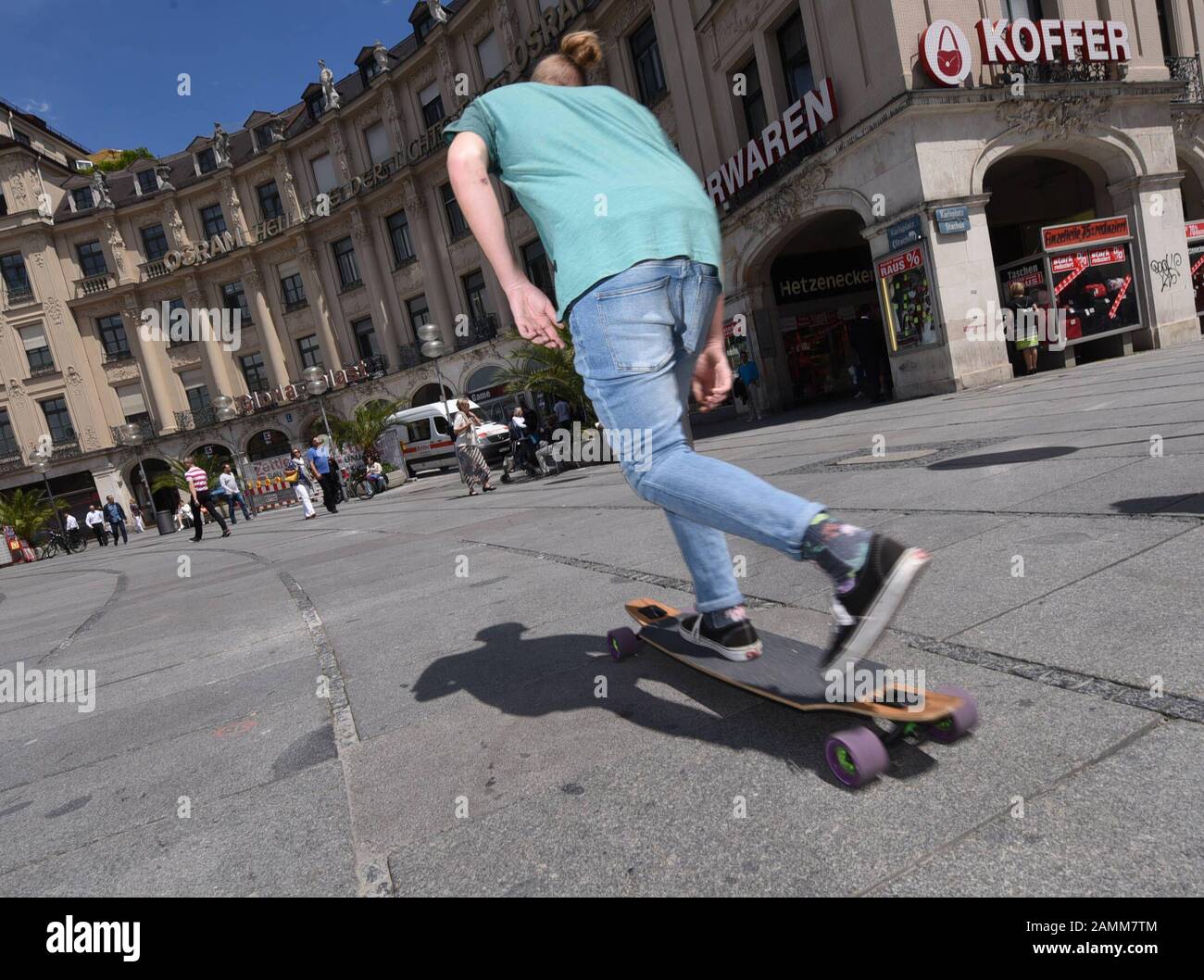 Longboard rider at the Stachus in the centre of Munich. [automated ...