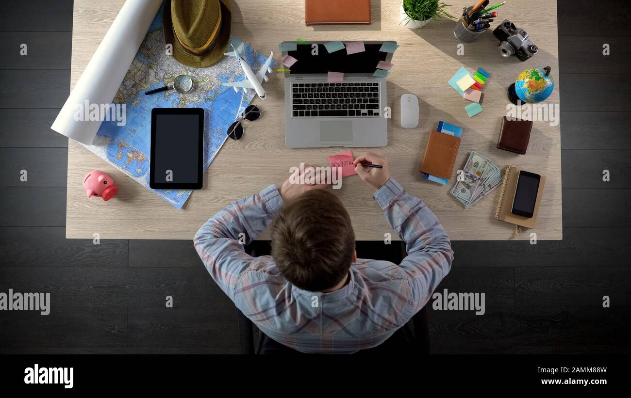 Man writing New York on sticky paper, choosing city for trip, travel ...
