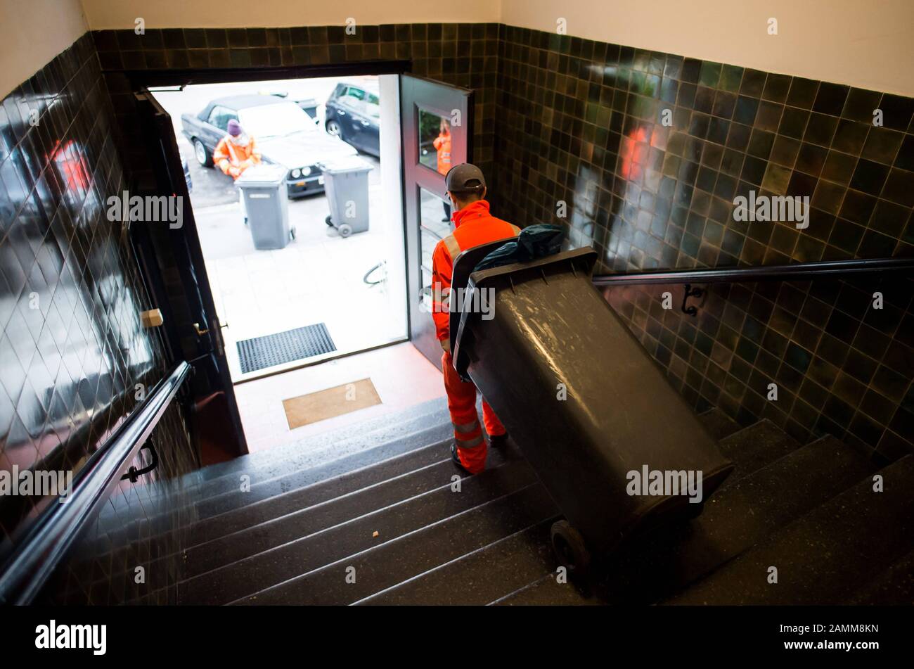 Employees of the municipal waste management company (AWM) at work in ...