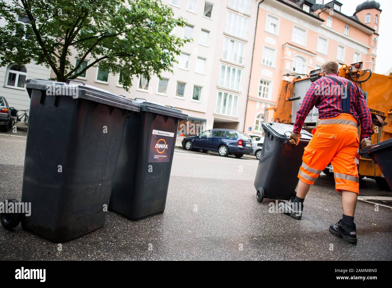 Employees of the municipal waste management company (AWM) at work in ...