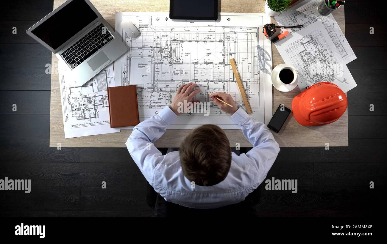 Architect making additional marks, drawing emergency exits in case of ...