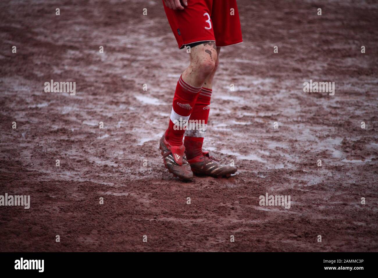 Football in mud hi-res stock photography and images - Alamy