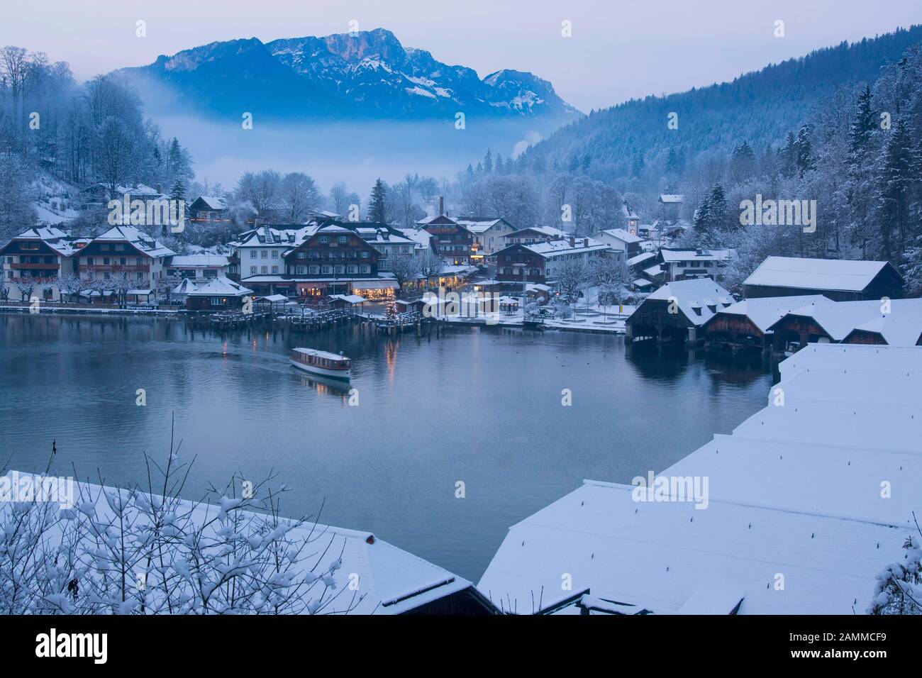the winter-evening lake district at Königssee in wintry illumination ...
