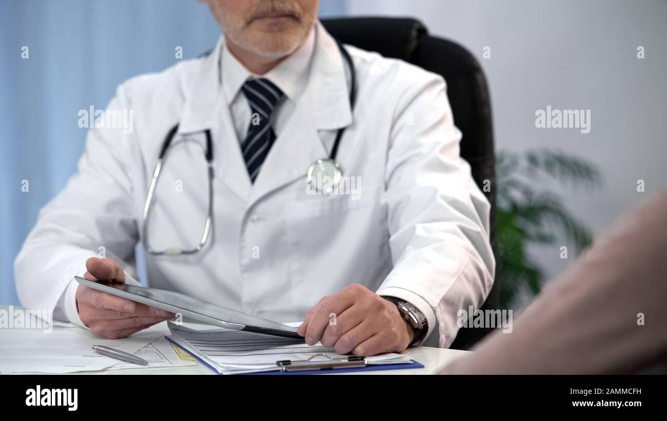 Doctor checking documents hi-res stock photography and images - Alamy