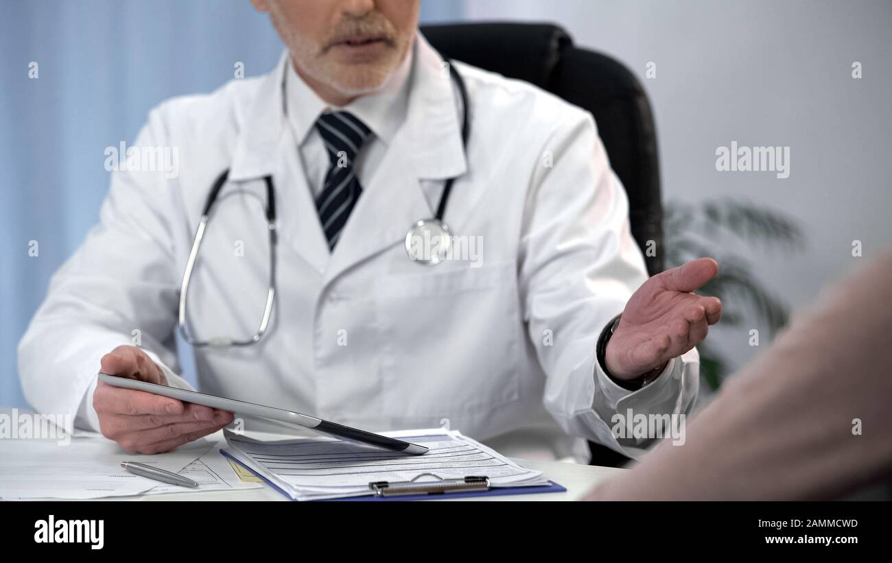 Doctor telling diagnosis to patient, discussing benefits of surgical ...