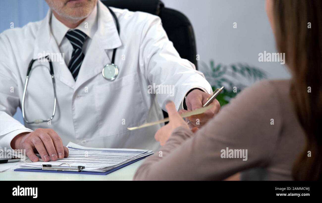 Doctor giving drug prescription to patient, qualified diagnosis and ...