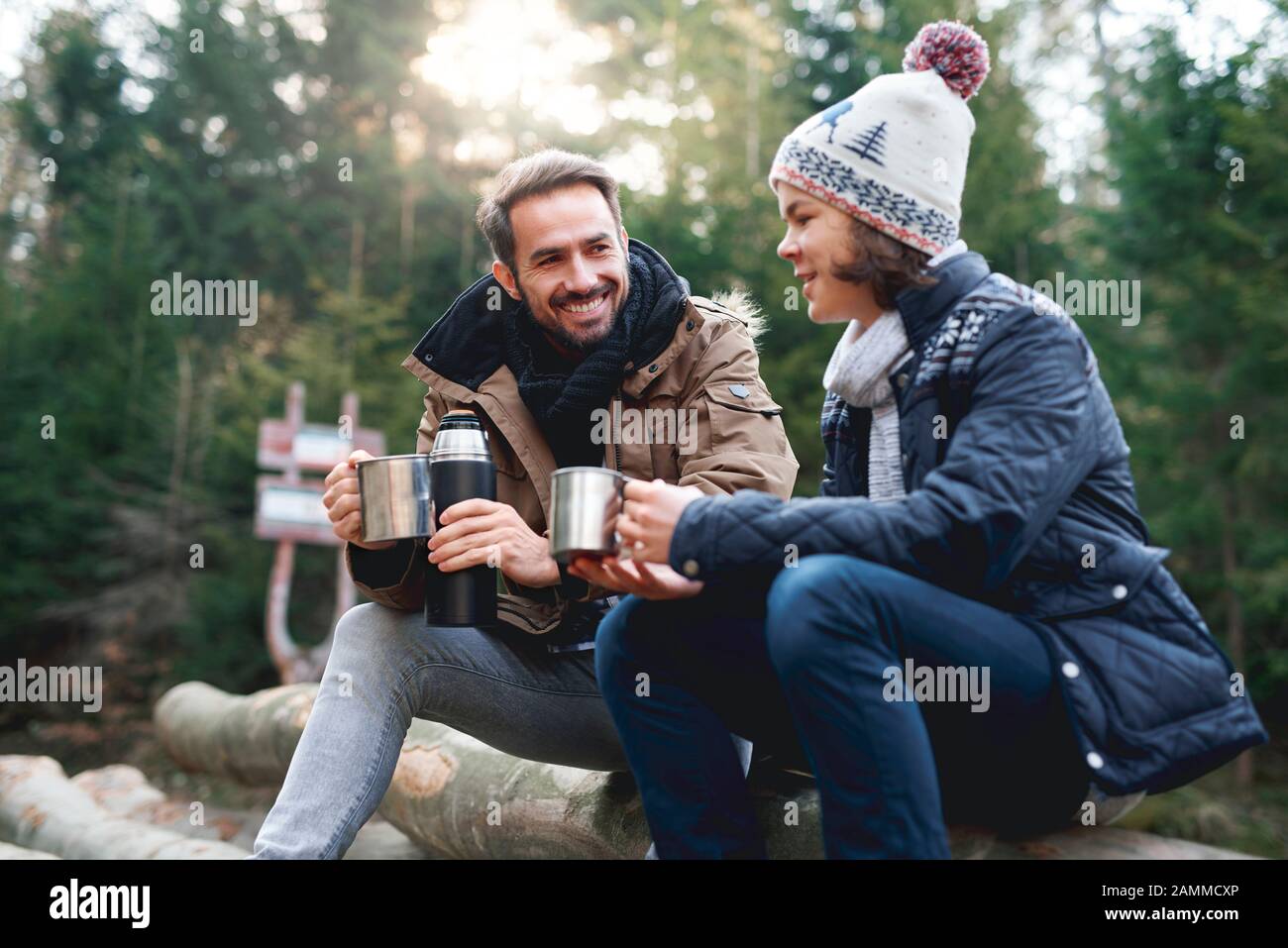 Happy dad and his son drinking tea in autumn forest Stock Photo - Alamy