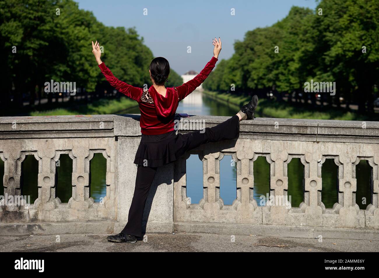 A teacher of Chinese folk dance during her morning stretching exercises ...