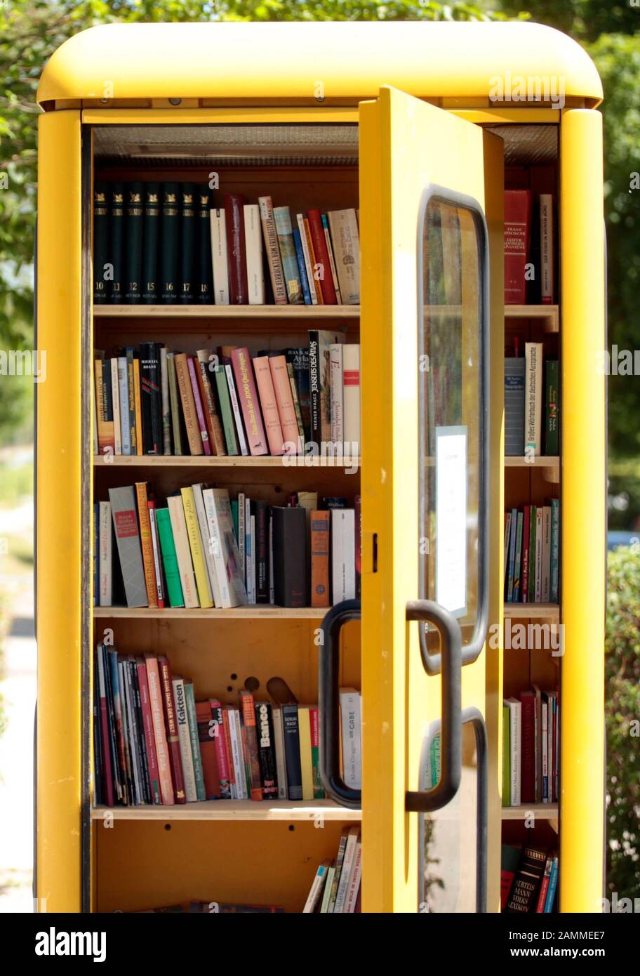 A telephone booth was converted into a mini-library and serves as a ...