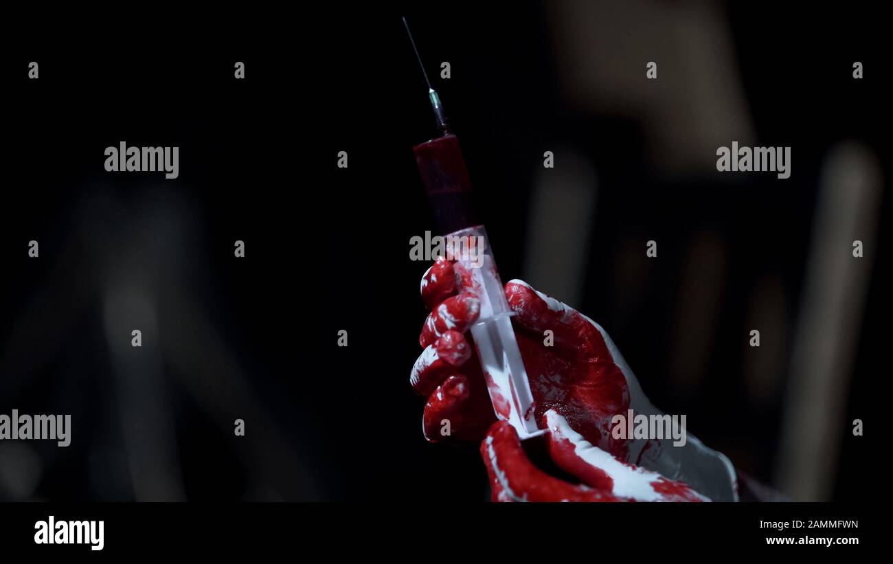 Mad person in latex gloves holding syringe with blood, virus injection ...