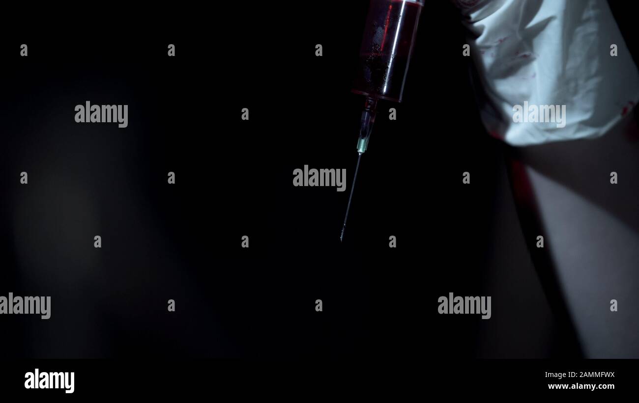 Scary blood syringe in doctors hand, deadly infection danger, terrible ...