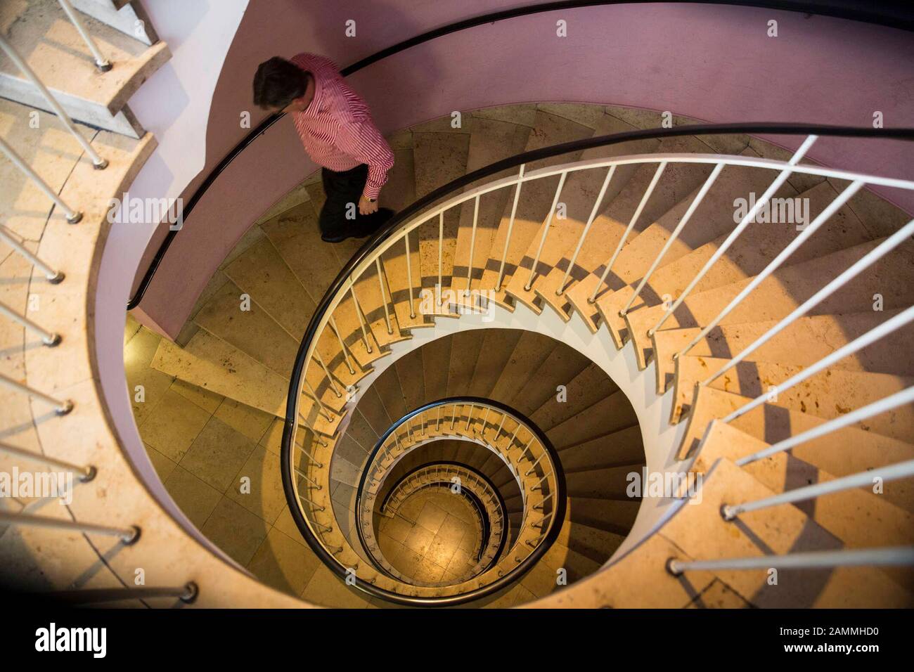 Man walking down spiral staircase hi-res stock photography and images ...