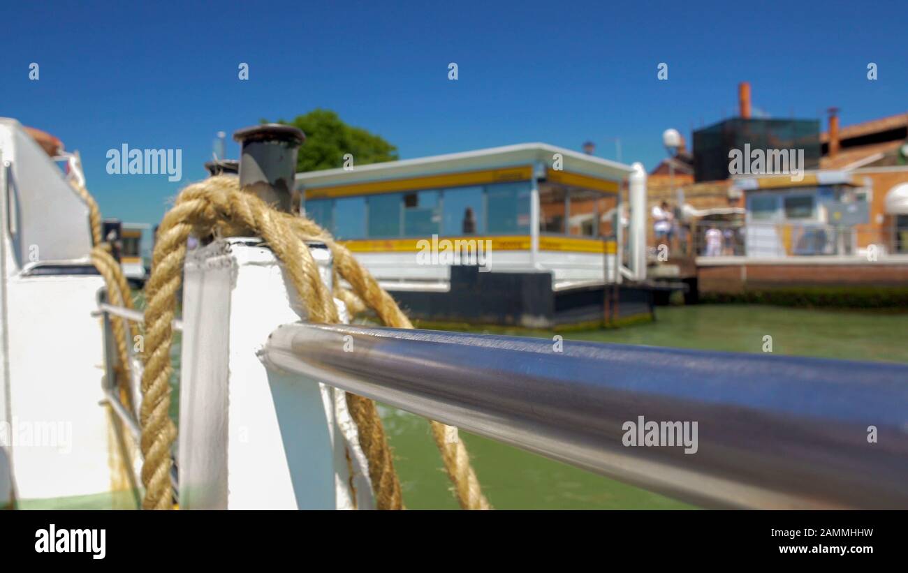 Thick rope tied on board of motor boat cruising canal, water transport ...
