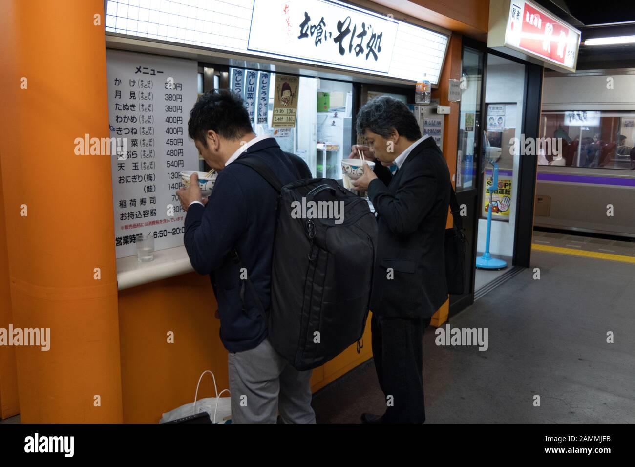 Japanese men eating noodles for breakfast and lunch in a small ...