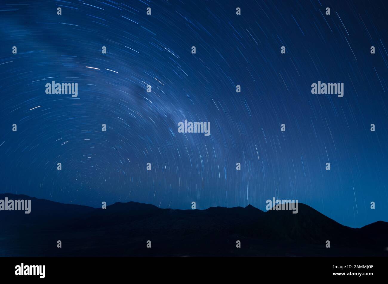 Extreme long exposure image showing star trails above the Bromo Volcano ...