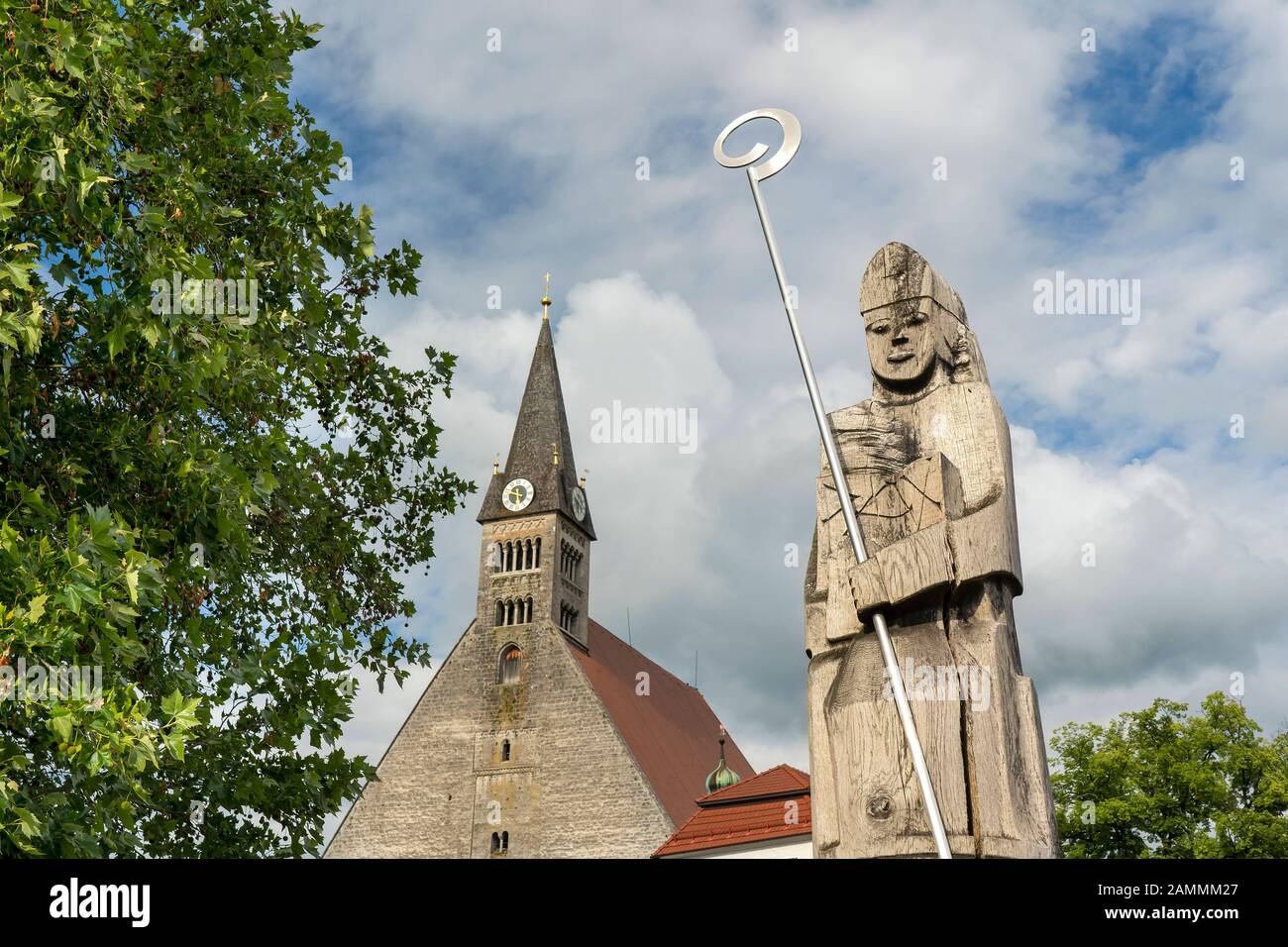 the figure of St. Rupert carved from mighty oak with the tower of the ...