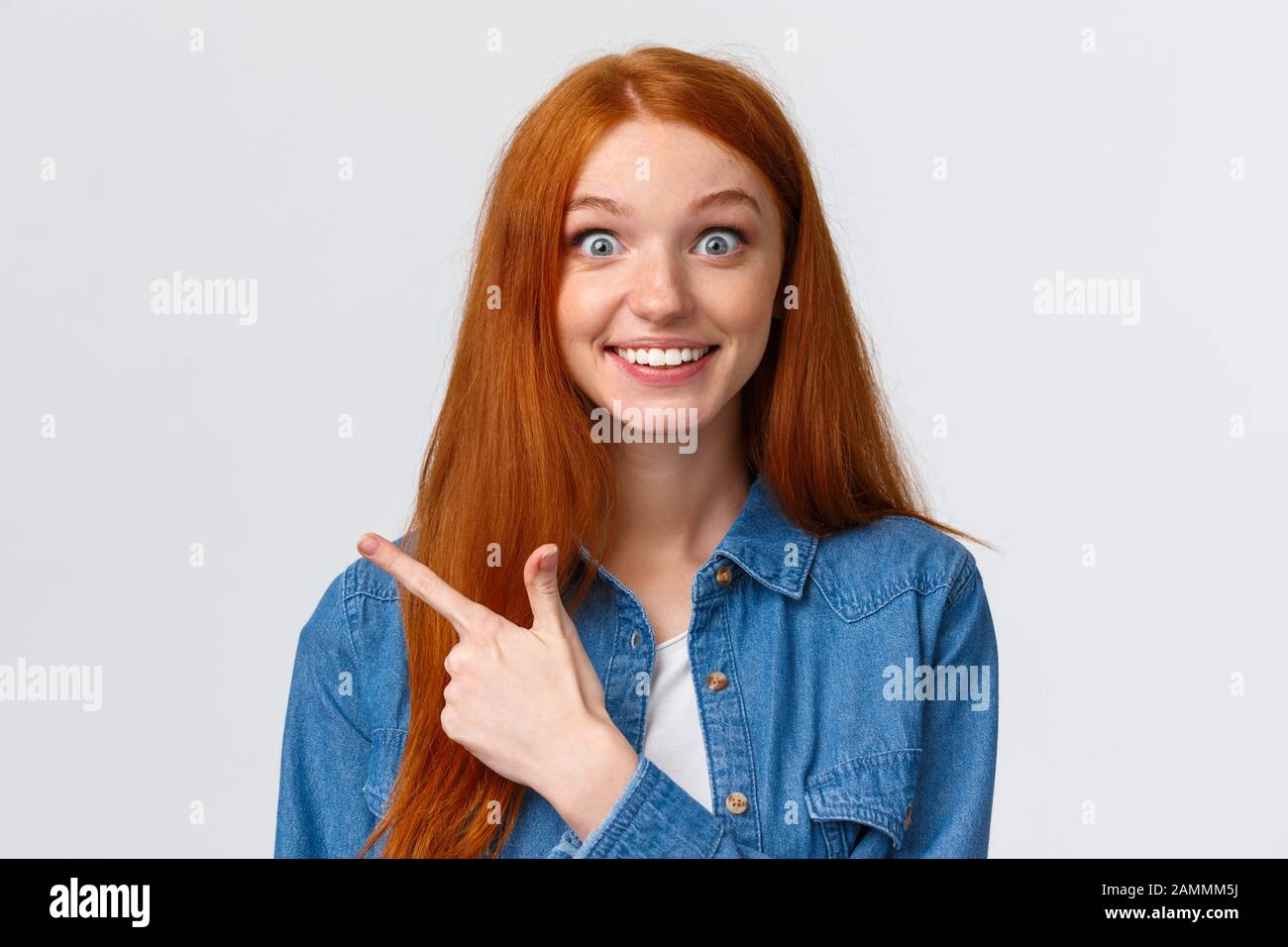 Excited and impressed, curious thrilled smiling redhead girl with long ...
