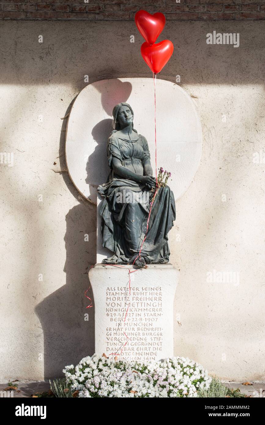 Grave figures decorated with heart-shaped balloons at the Old South ...