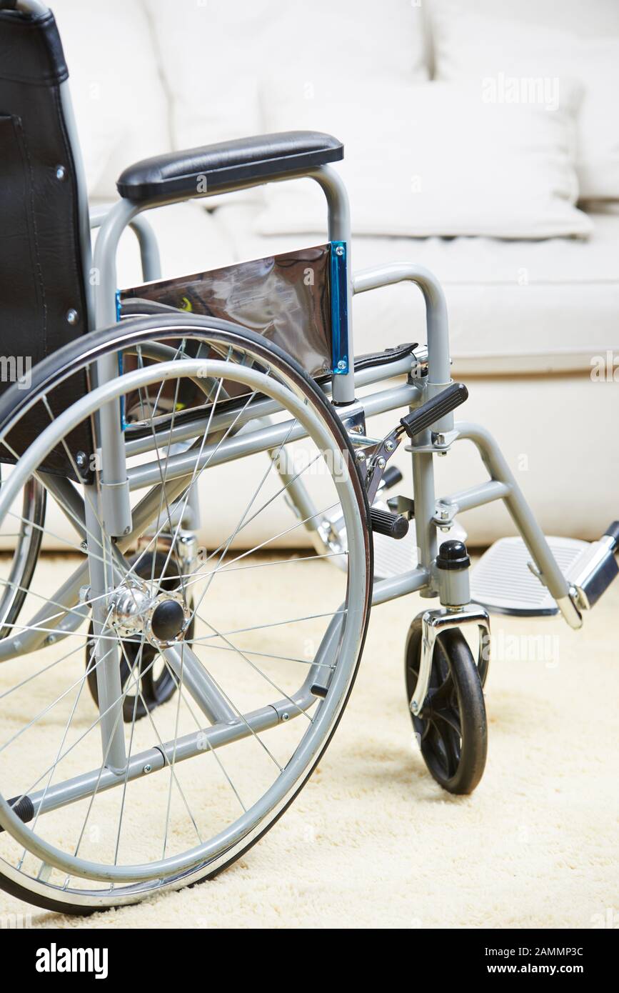Empty wheelchair is standing in a living room Stock Photo - Alamy