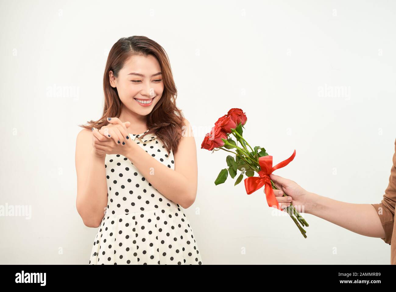 Young woman receiving a bunch of roses on a date Stock Photo - Alamy