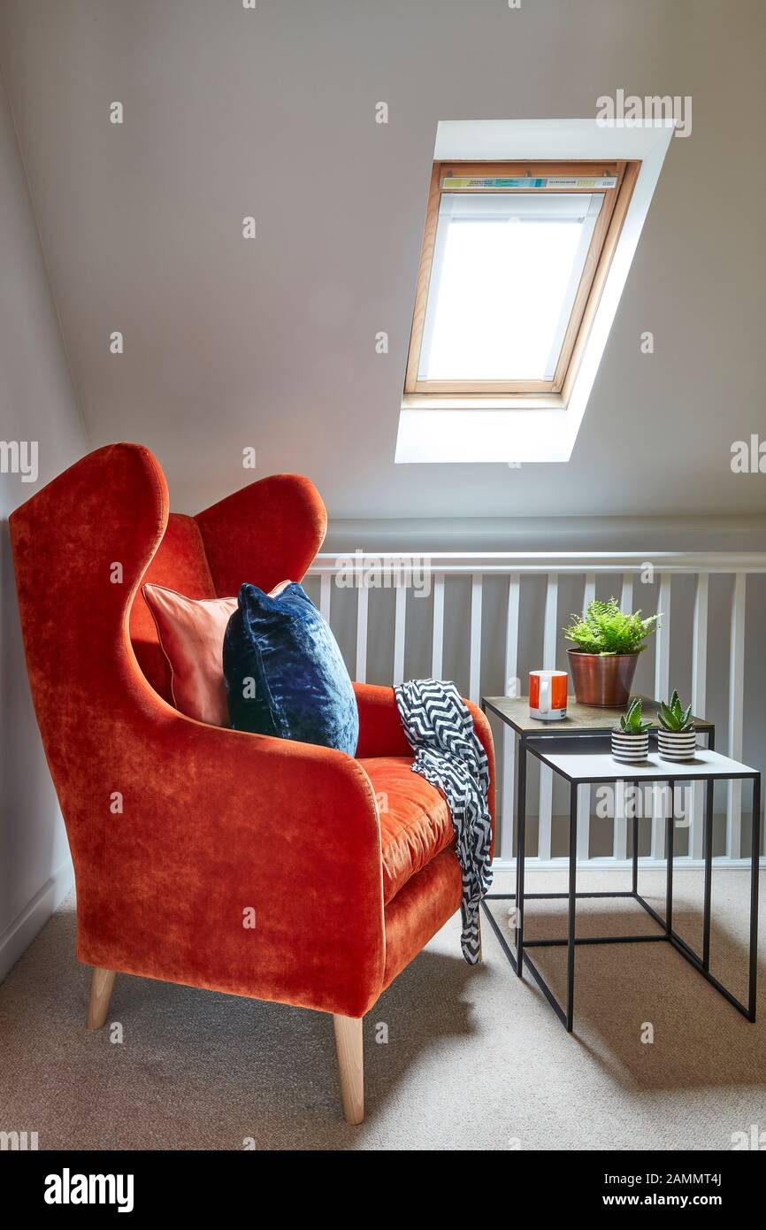 orange chair on landing Stock Photo - Alamy