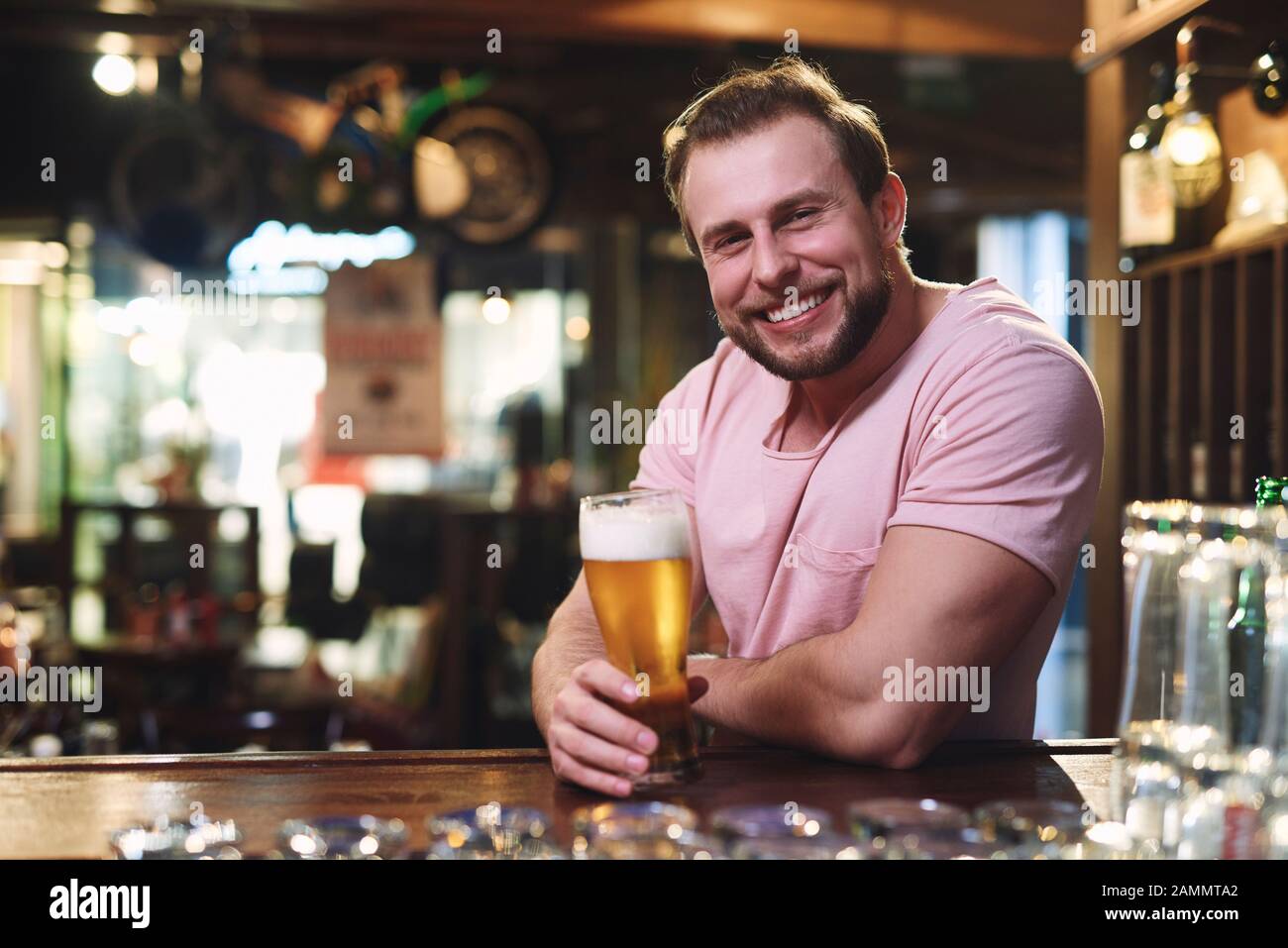Portrait of smiling man drinking beer in the pub Stock Photo - Alamy