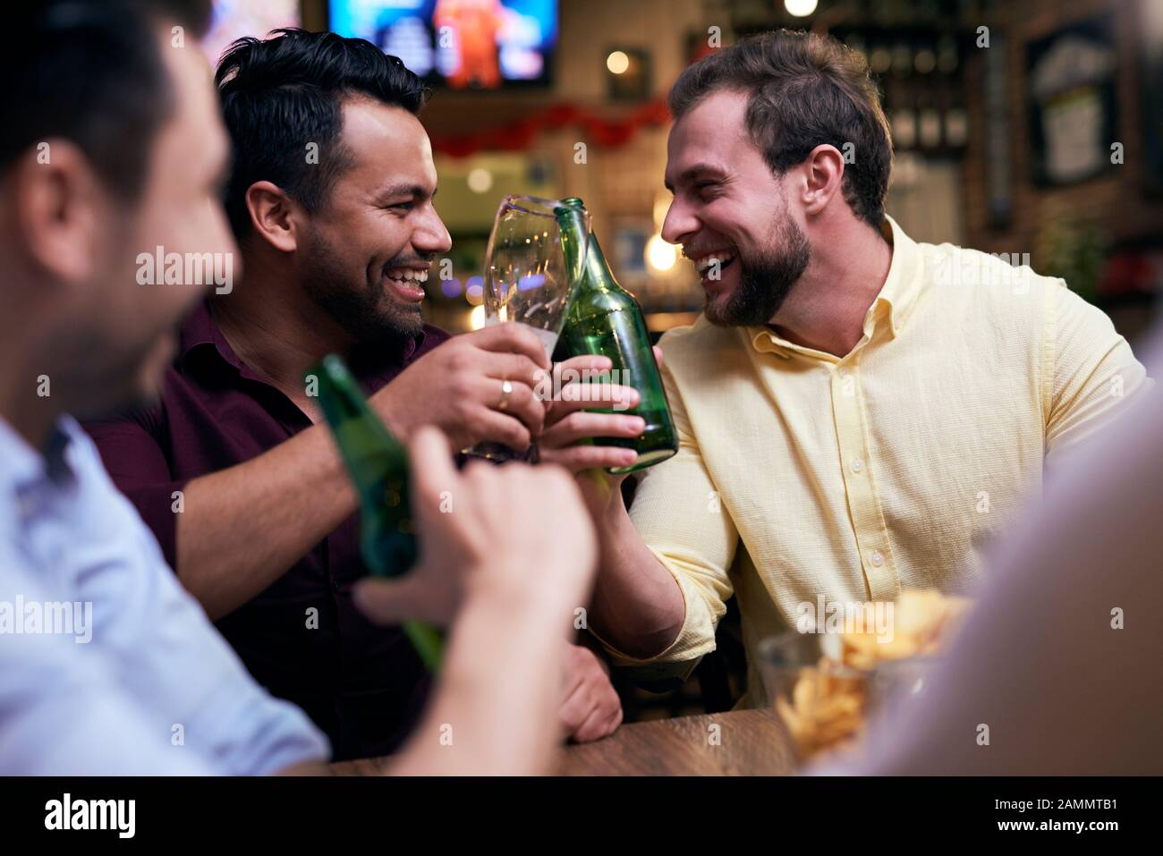 Men chilling with drinks in the pub Stock Photo - Alamy