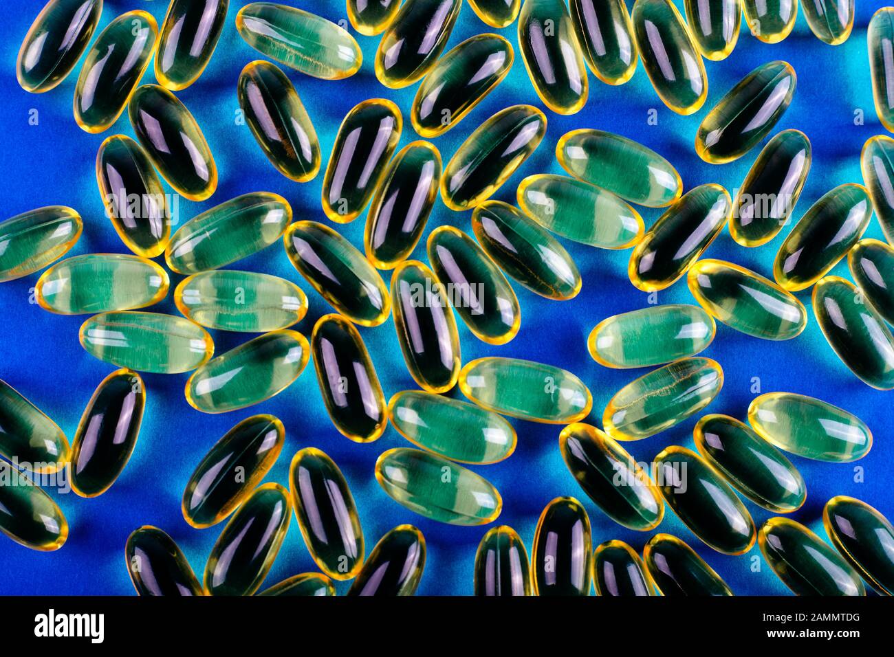 Omega 3. Fish oil capsules on blue background and texture, vitamin D ...