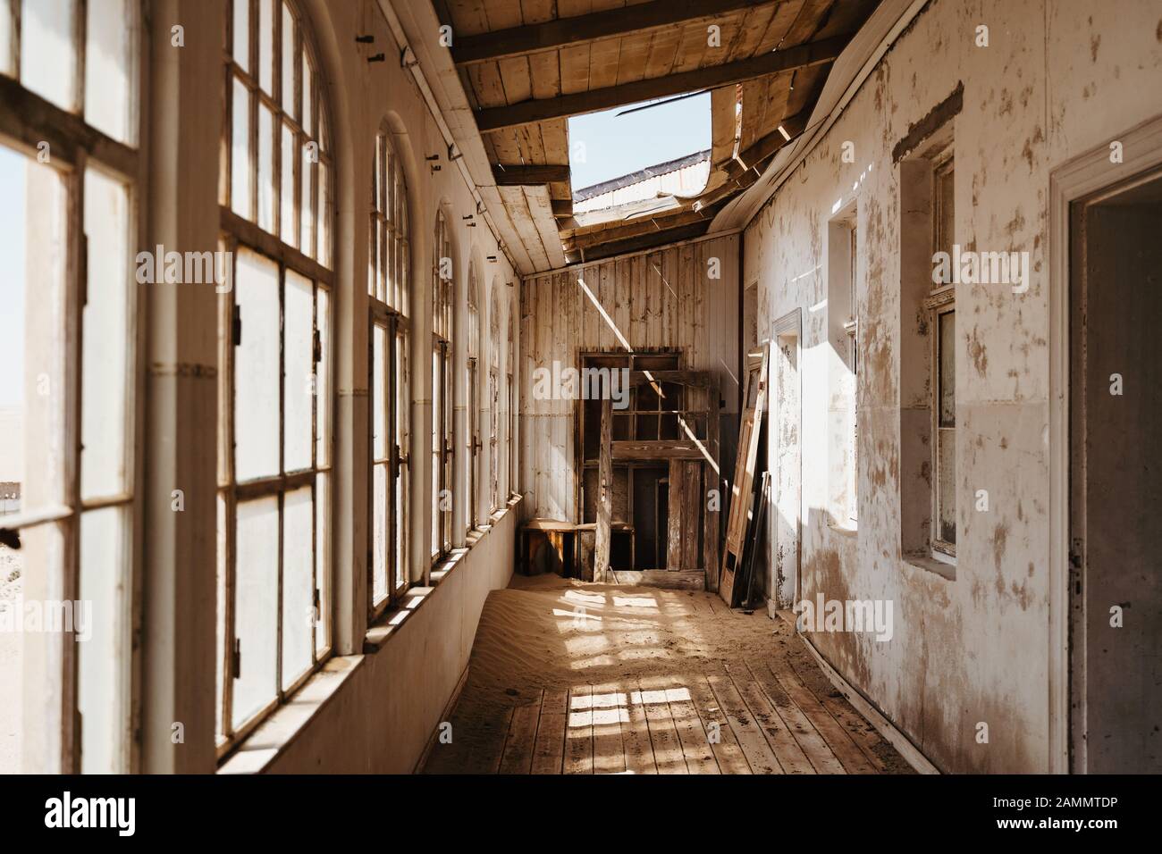 beautiful western villa with big windows and desert sand coverding the ...