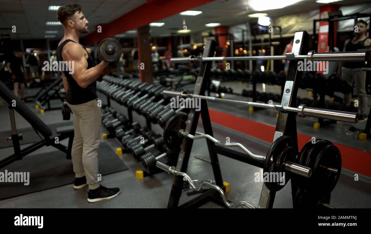 Man flexing muscles mirror hi-res stock photography and images - Alamy