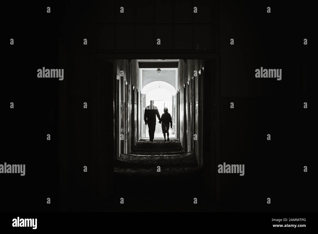 couple holding hands and walking into light together Stock Photo - Alamy