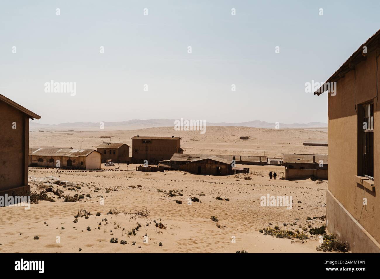 Abandoned buildings left to rot in wild west scenery with desert sand ...
