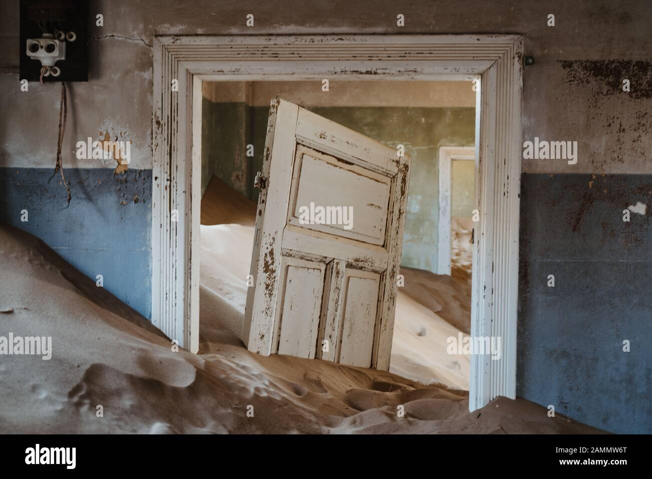 door left stuck in desert sand inside old house Stock Photo - Alamy