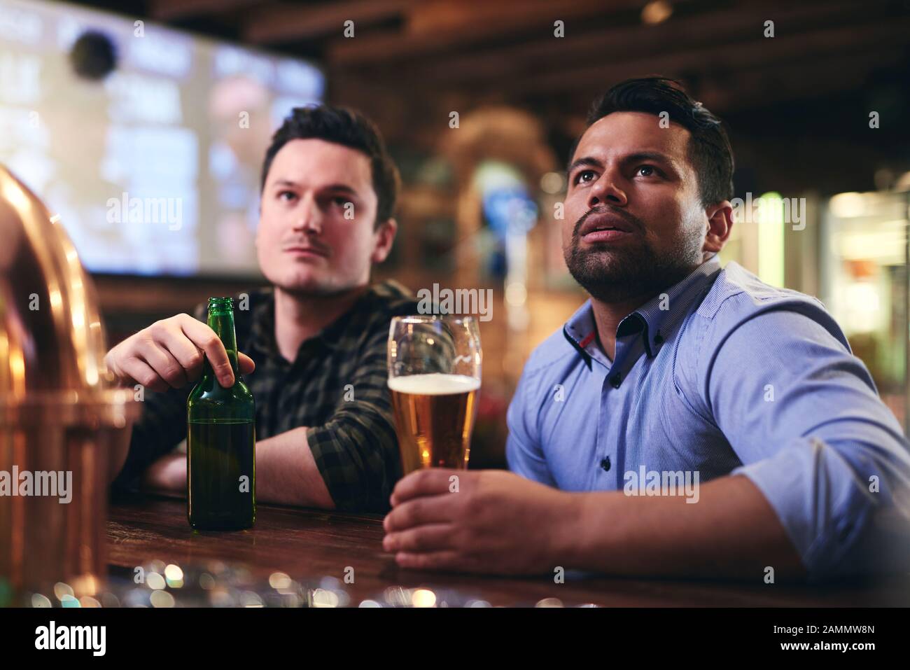 Focused men watching football game Stock Photo - Alamy
