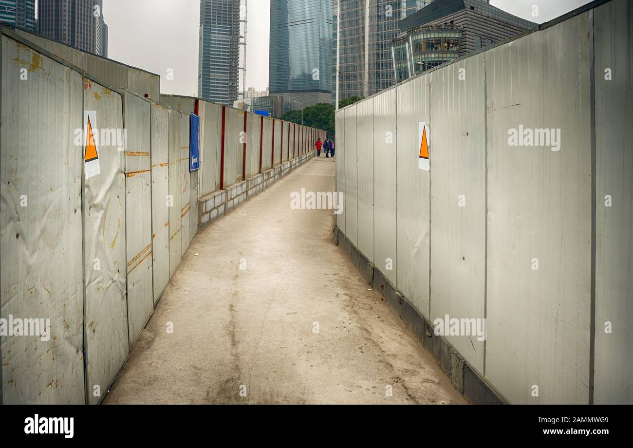 Narrow pedestrian gateway in the middle of construction site protected ...