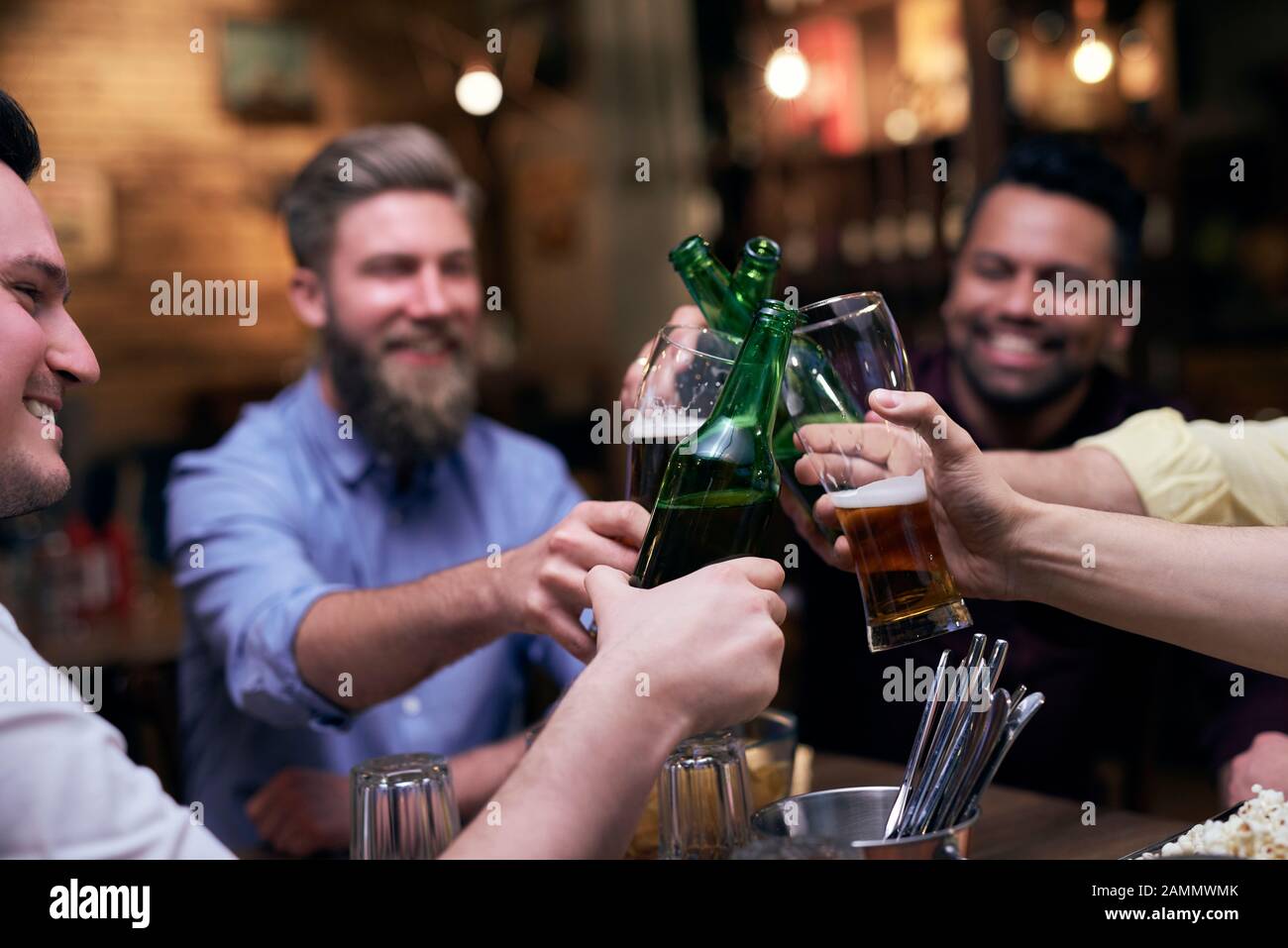 Group of men making a cheers for good weekend Stock Photo - Alamy