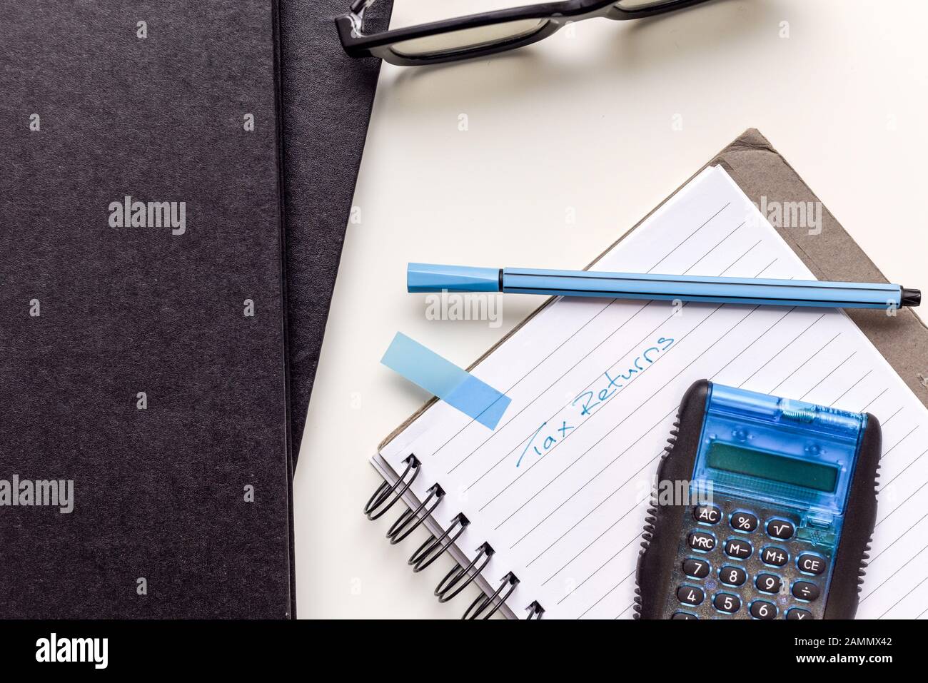 Calculating tax return numbers and figures on office desk concept for ...