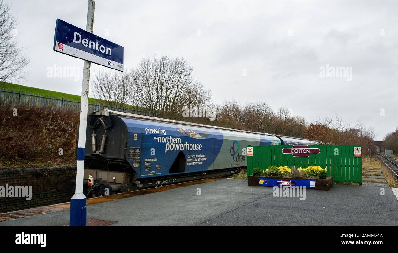 A freight train passes through Denton Station, in Greater Manchester ...