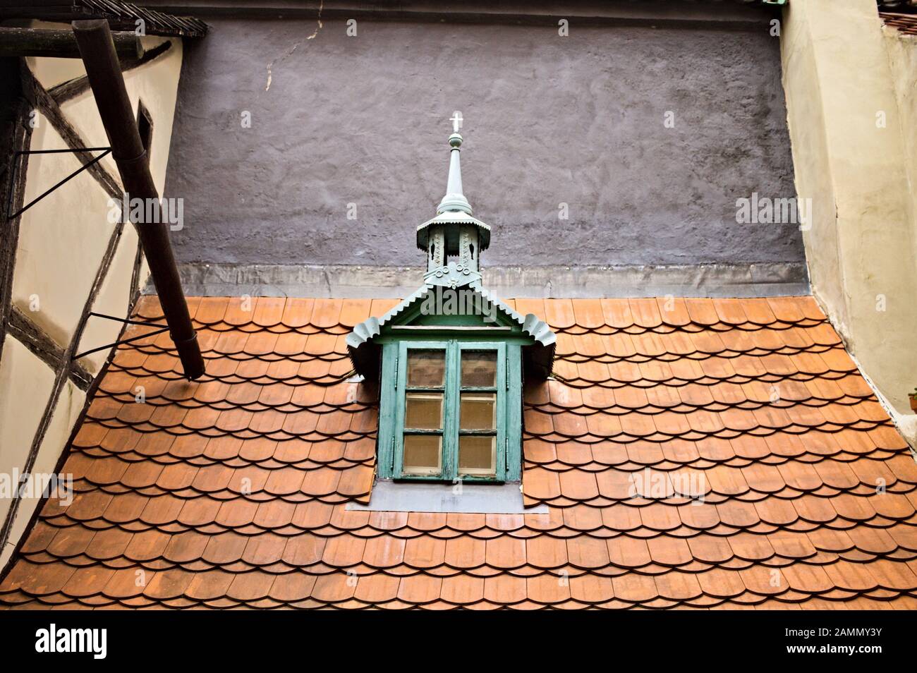 Isolated gothic and baroque window with a spire in a roof with tiles ...