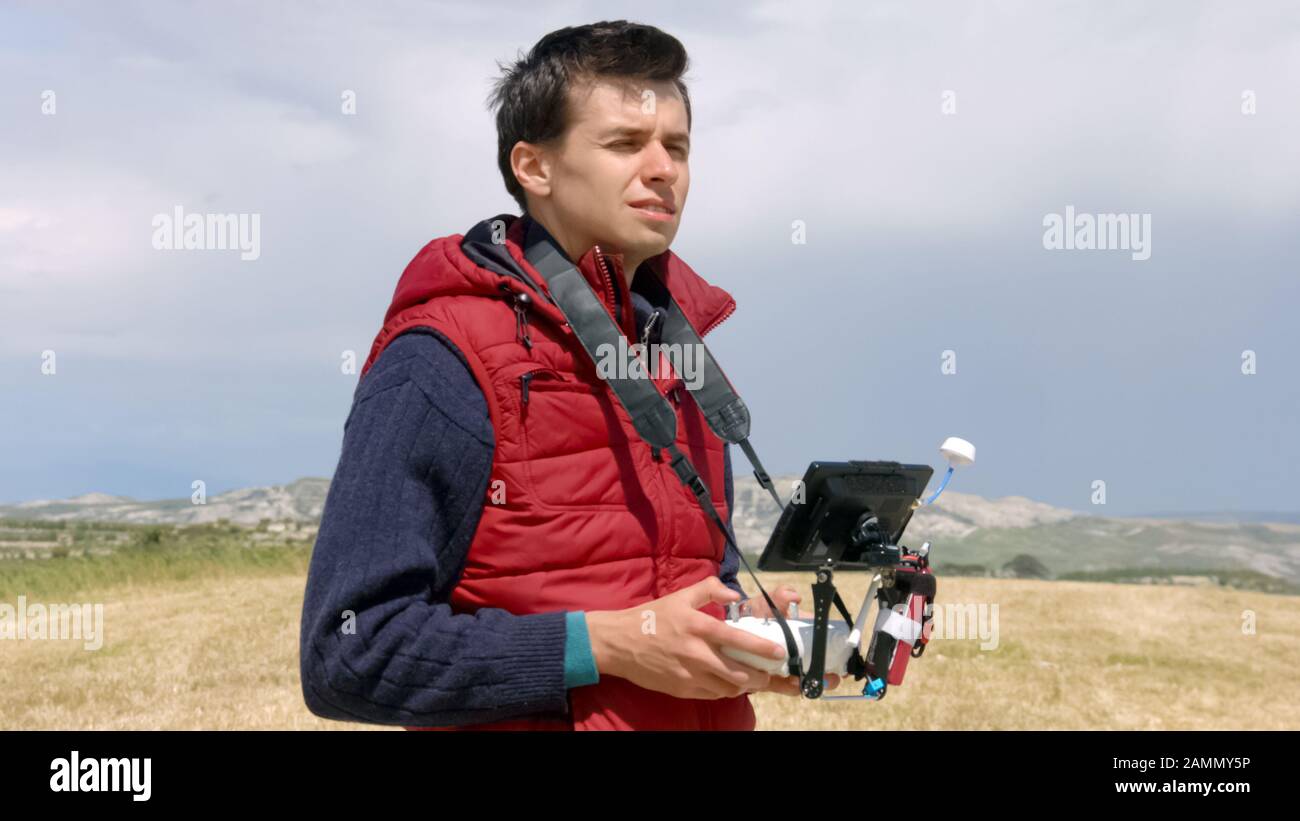 Man controlling quadrocopter flight, professional cameraman filming ...