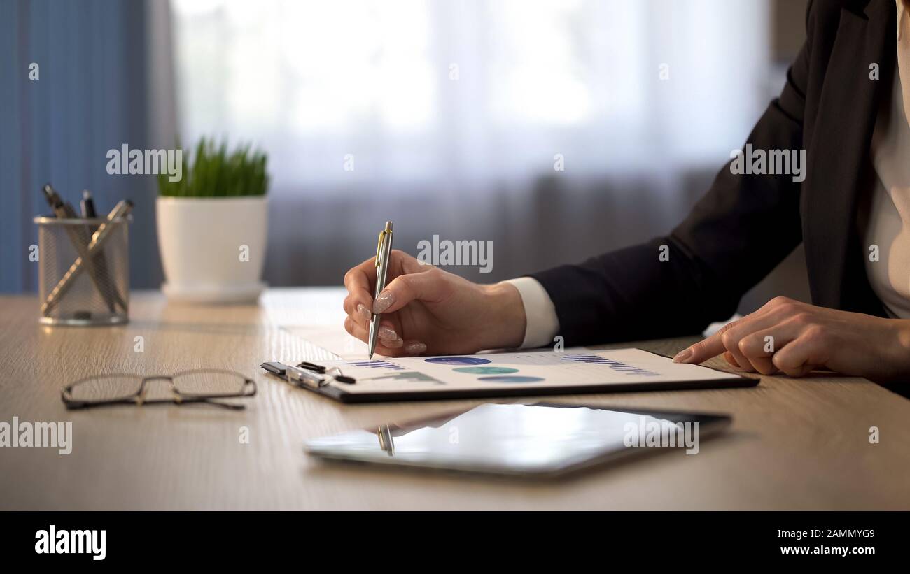 Lady boss looking at statistical graphs, loan review check, financial ...