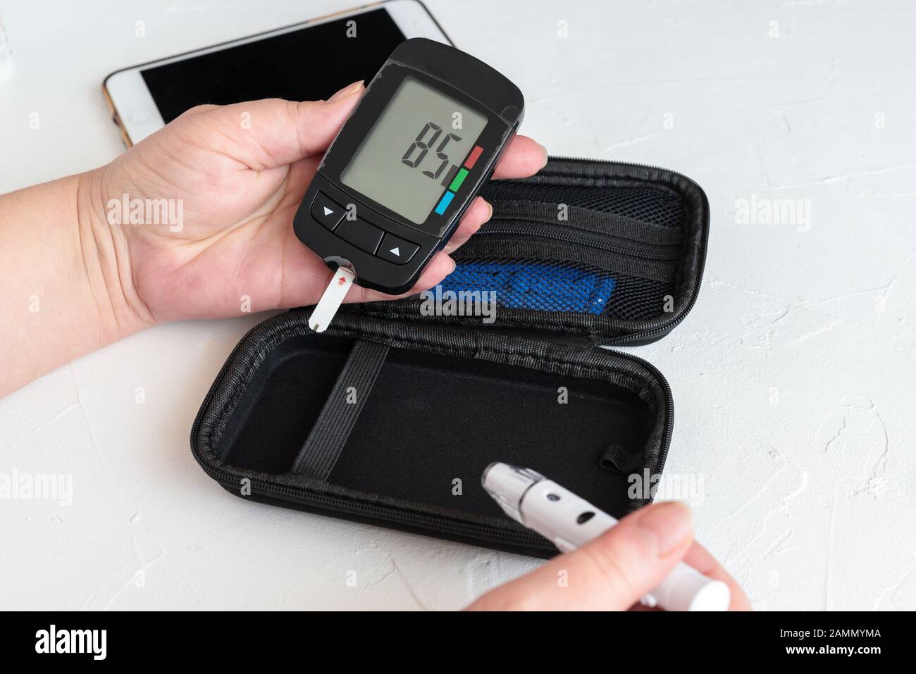Patient hands measuring glucose level blood test with glucometer Stock ...