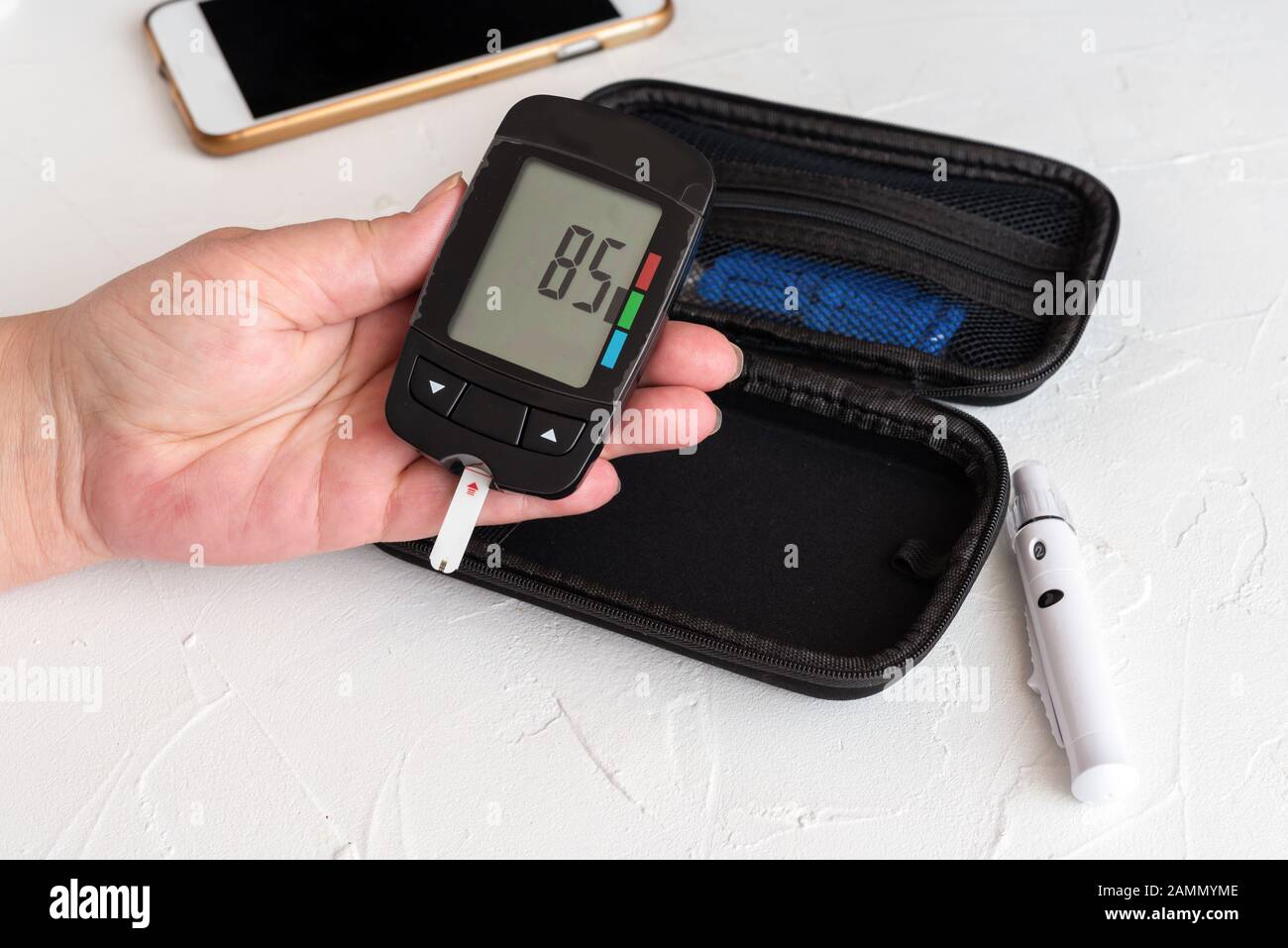 Patient hands measuring glucose level blood test with glucometer Stock ...