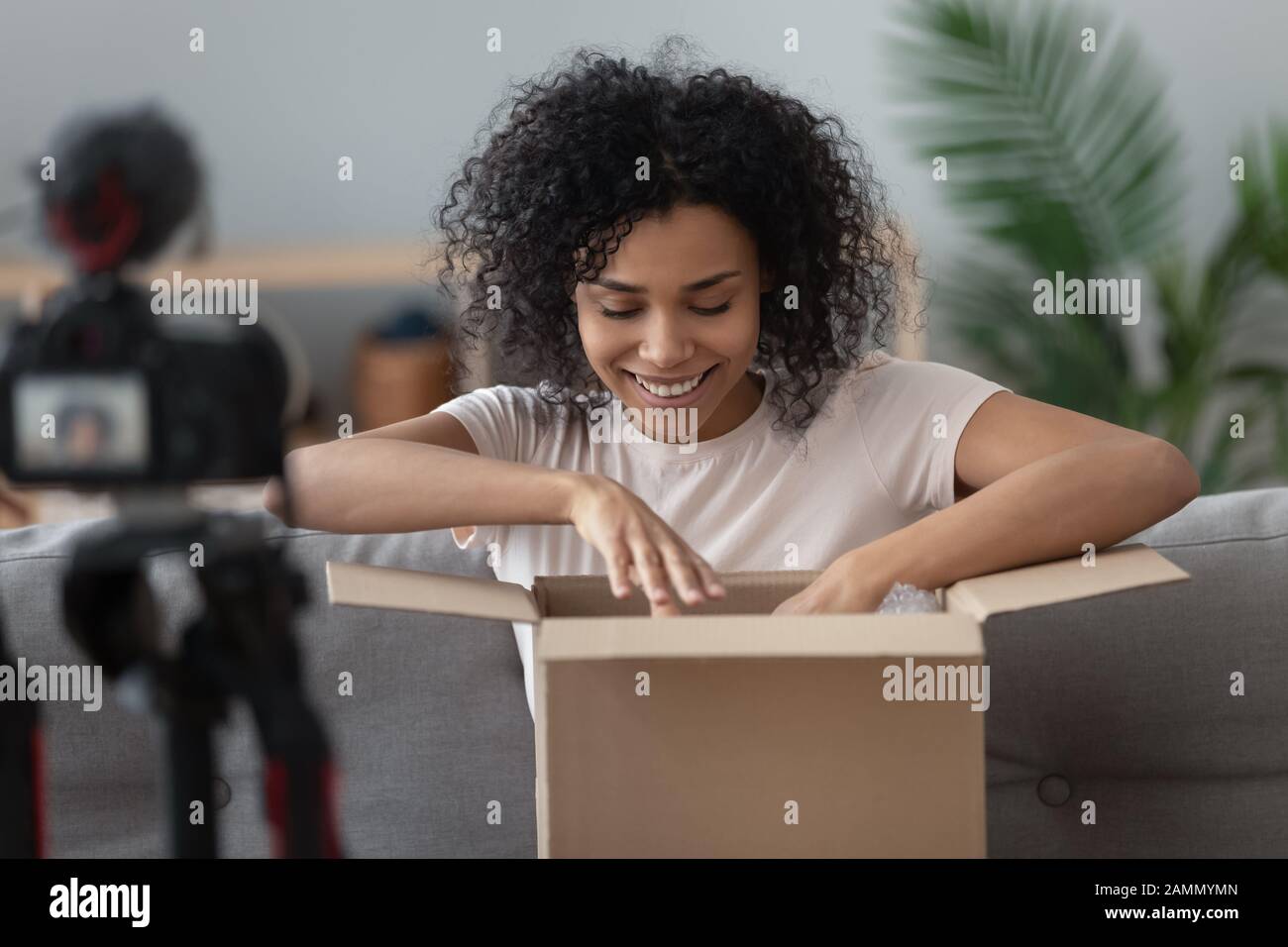 African woman captures on camera moment of unpacking ordered goods ...